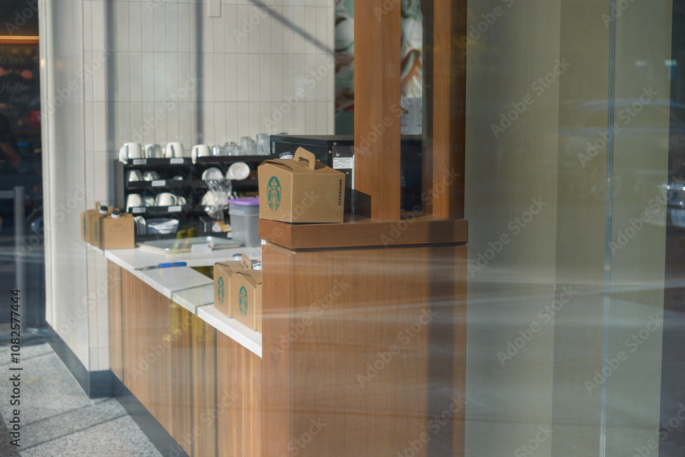 through a curtain glass wall view of Starbucks, a coffee shop chain ...