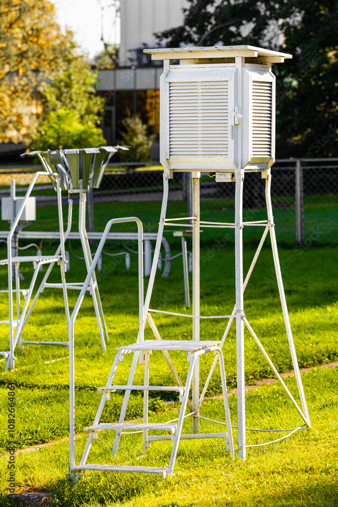 meteorological booth on a stand with an extension ladder ...