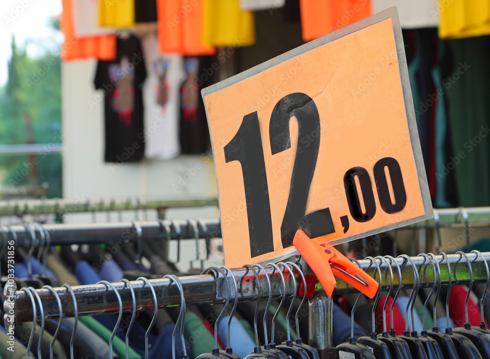 clothes and Price tag with 12 text on a market stall item Stock Photo ...