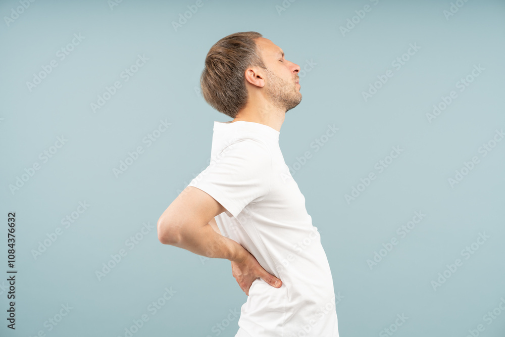 Poster Unhappy man struggles with severe lower back pain by prolonged ...