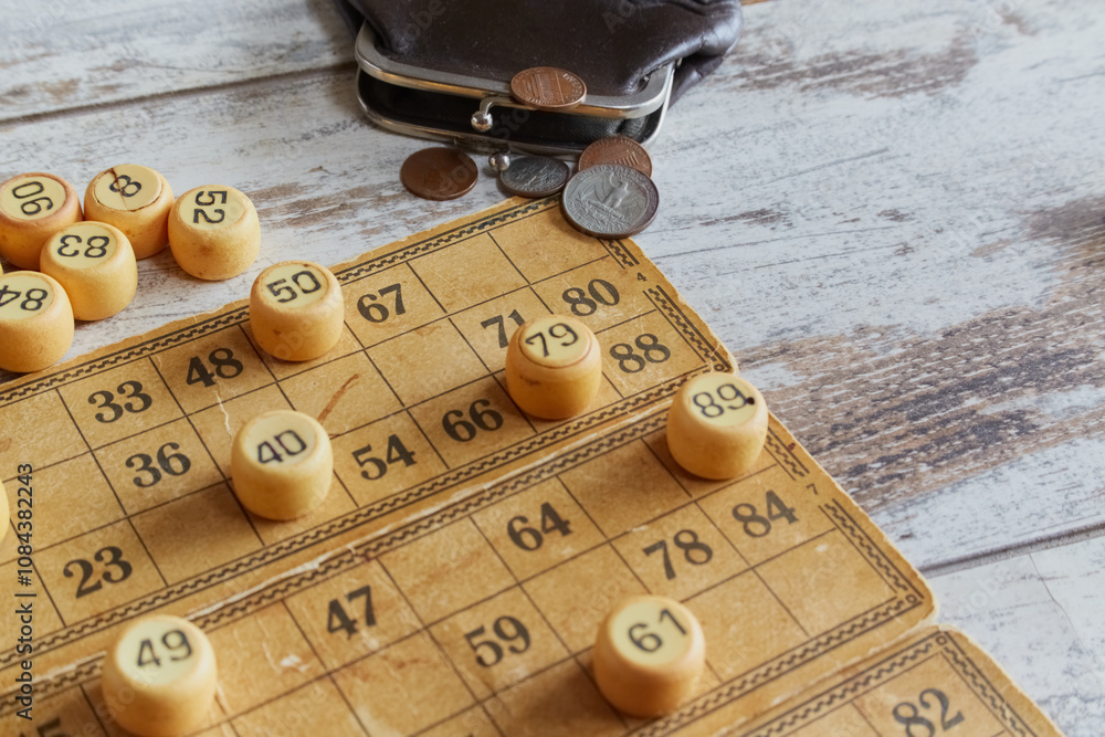US cents coins from an old wallet next to vintage old bingo game cards ...