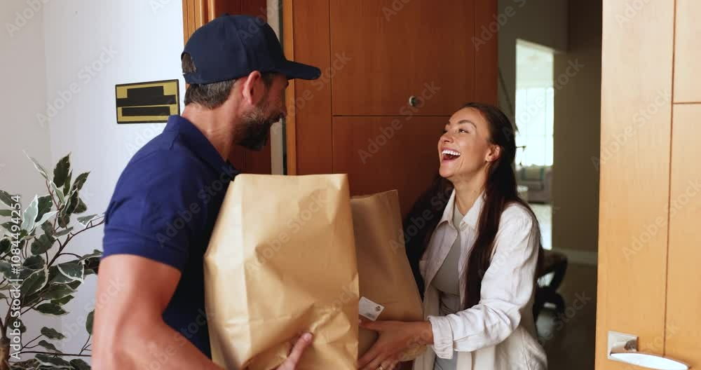 Happy courier man carrying paper packages to customers apartment door, giving grocery shopping ...