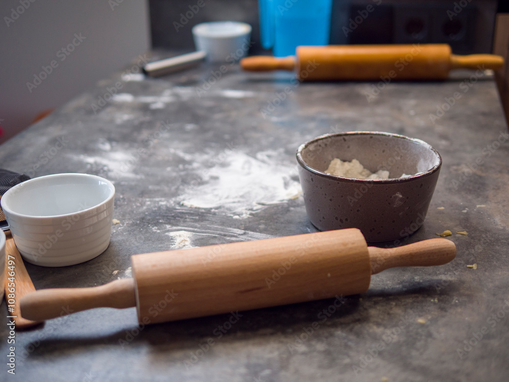 Cozy kitchen counter with rolling pins, bowls, and flour, creating ...
