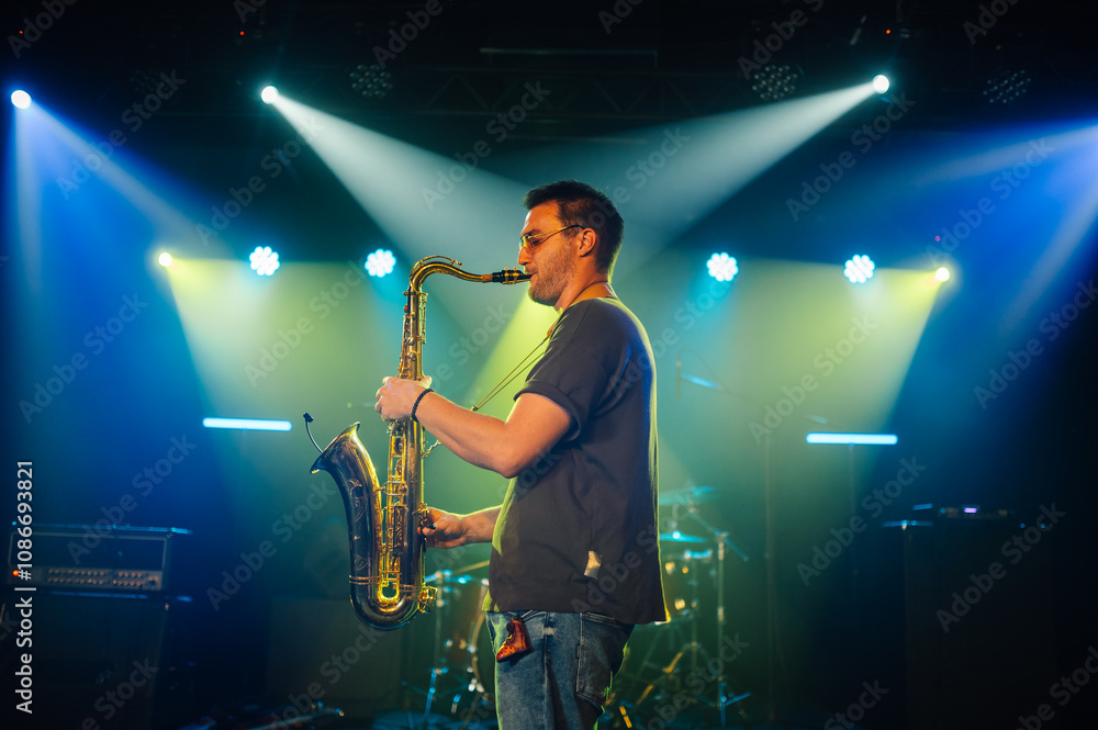 Saxophonist performing live on stage with dramatic lighting Stock Photo ...
