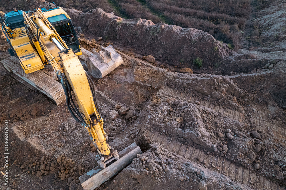 drone view, aerial image of an earth excavator digging a trench at a ...