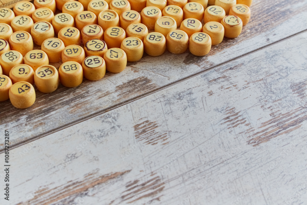 Bingo tokens from a bag gathered at the top on an old worn surface of a ...