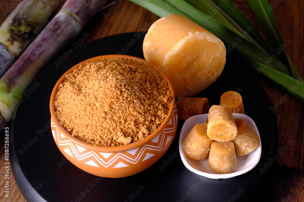 Jaggery powder with jaggery cubes. Jaggery is used as an ingredient in ...