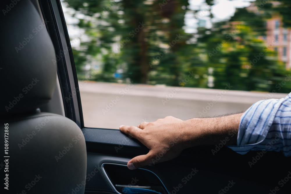 Hand of passenger on a taxi window during a trip while the car is ...
