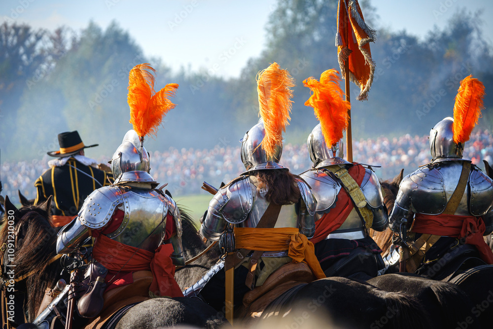 Honorable knights in armor with orange feathers and plumes riding on ...