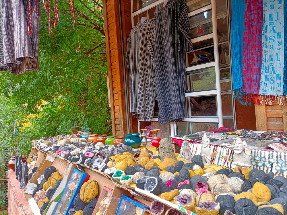 Moroccan shop displaying clothes, minerals, and handicrafts Stock Photo ...
