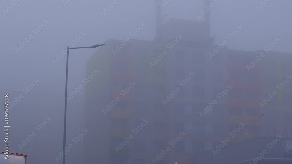 In a foggy urban landscape, a majestic building shrouded in mist ...