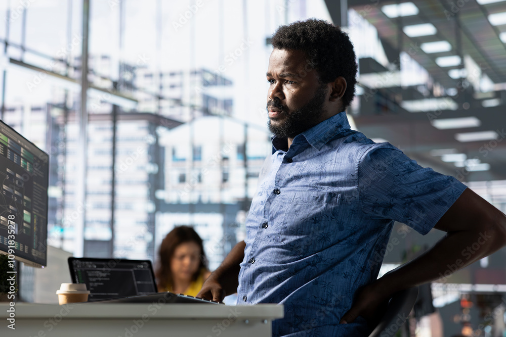 Data scientist feeling back pain from sitting down too much while creating machine learning ...