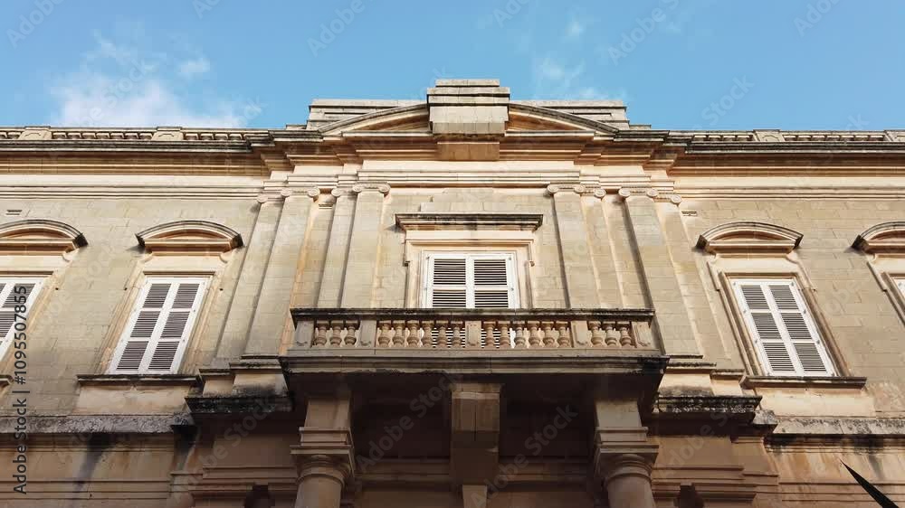 Traditional facade of an old authentic building with red doors on the ...