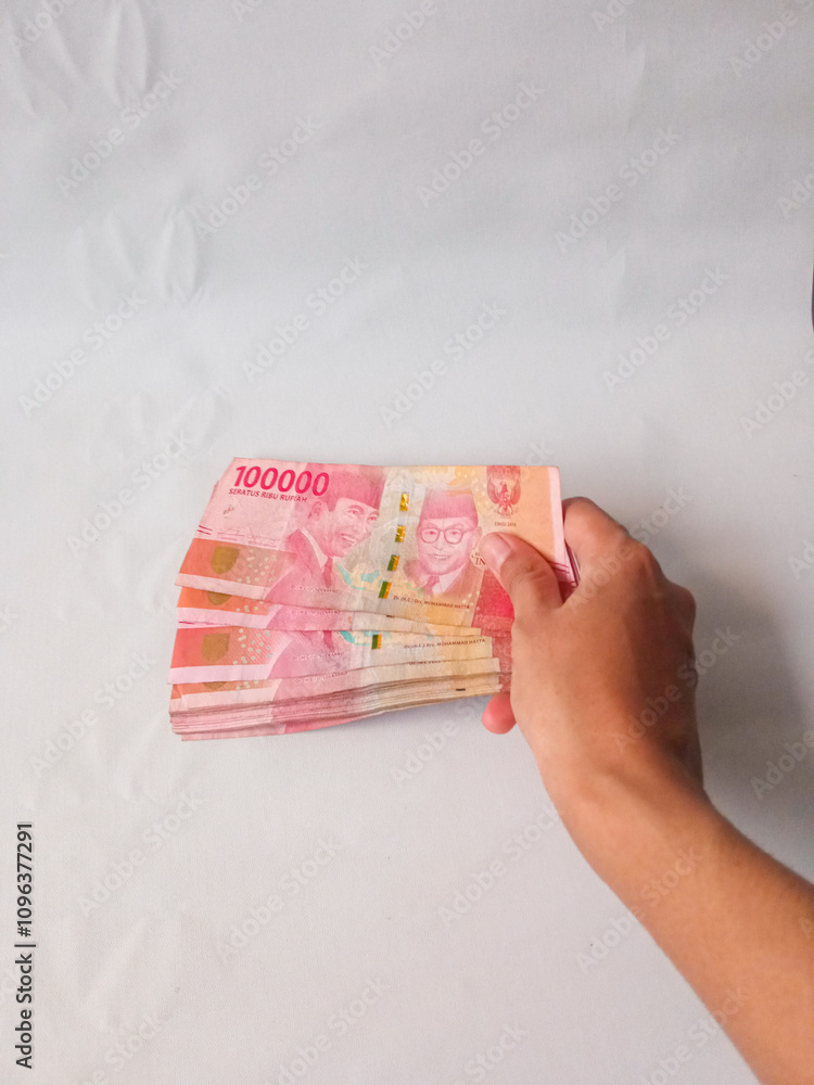 Cash payment concept. Indonesian rupiah currency (Rp. 100.000 Seratus ...