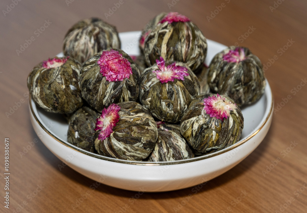 Unique tea flowers that are tightly rolled into spherical shapes that ...