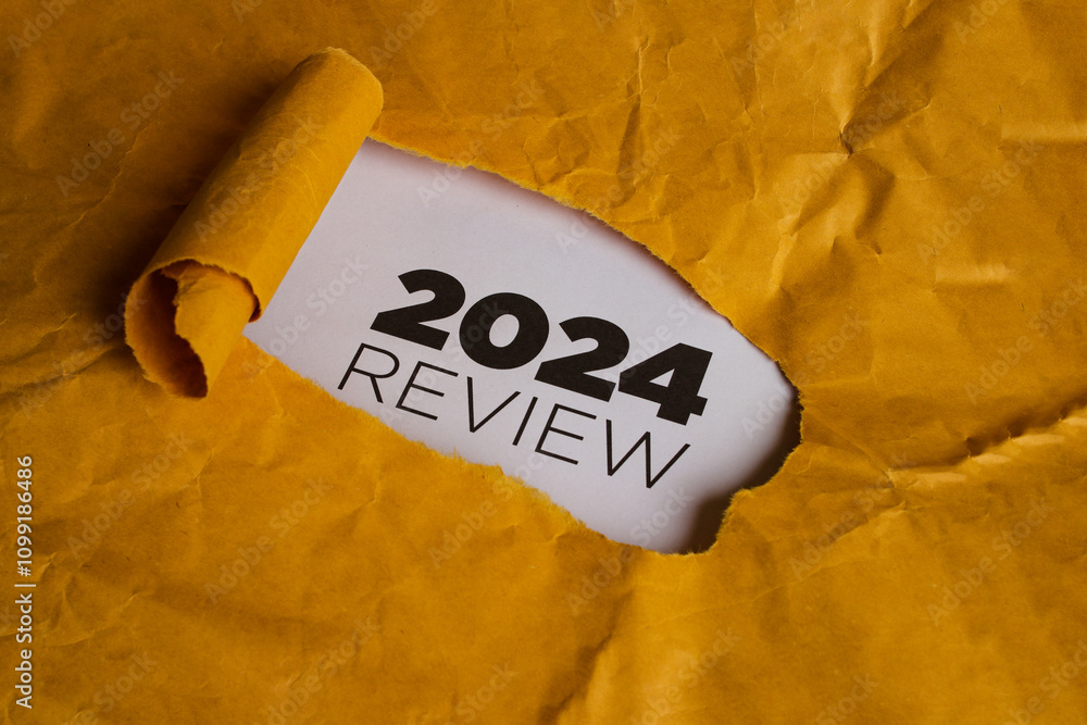 Foto de A yellow piece of paper with a hole torn in it. Through the hole, a white piece of paper ...