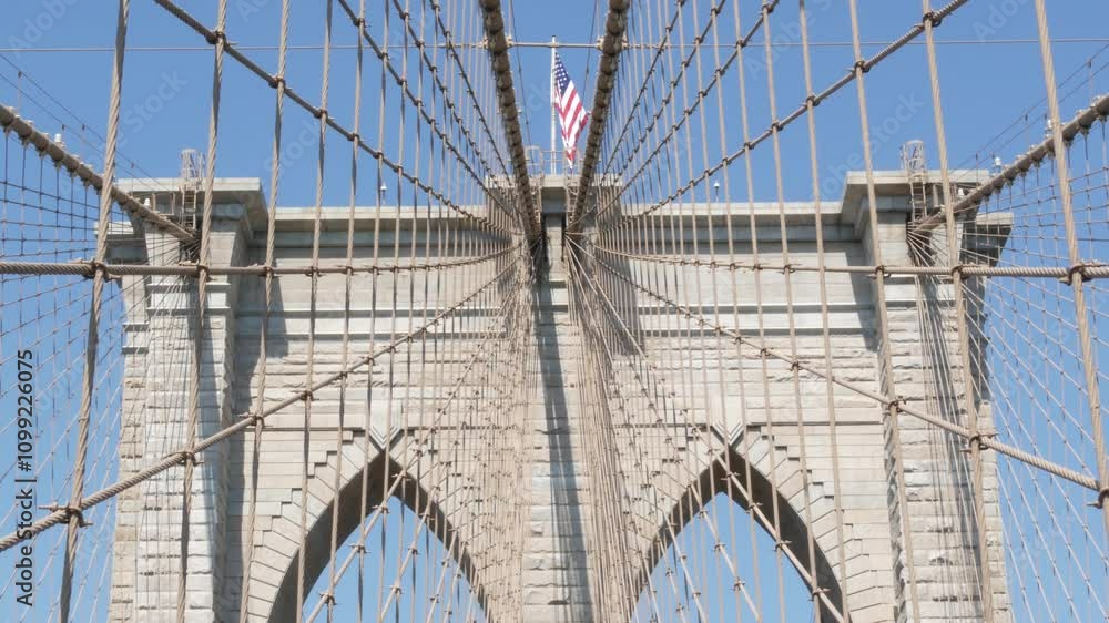 Brooklyn Bridge to Manhattan downtown, cables and blue sky. New York ...
