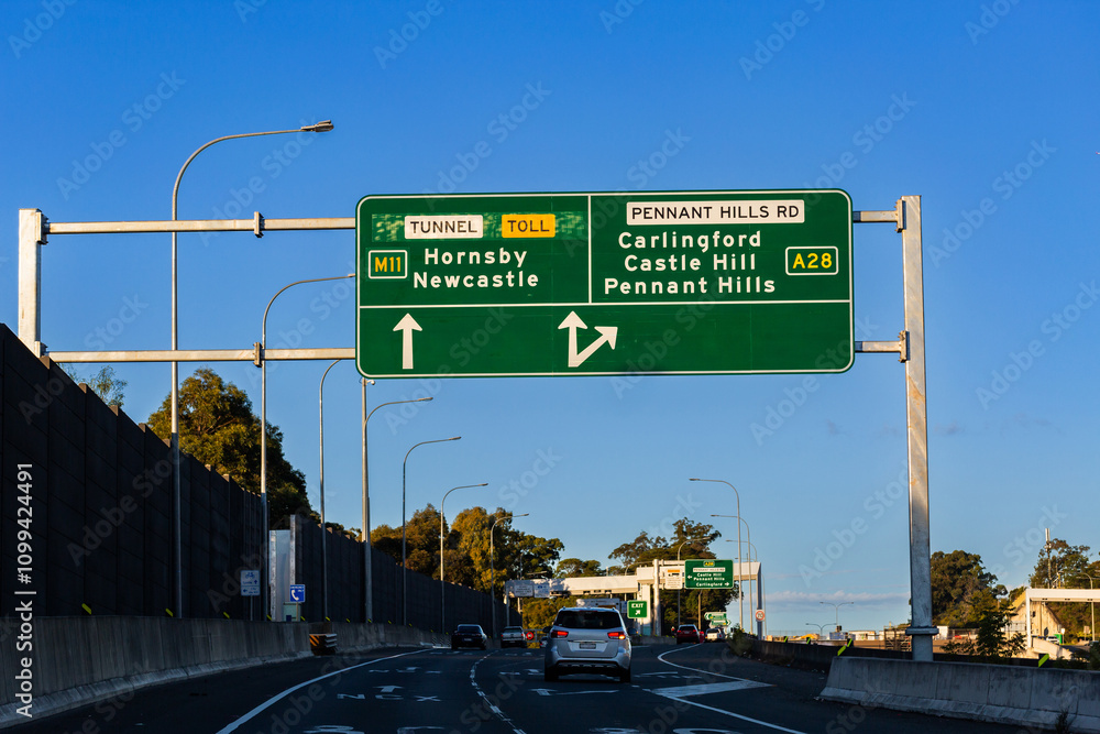Green overhead road signage before NorthConnex tunnel with directions ...