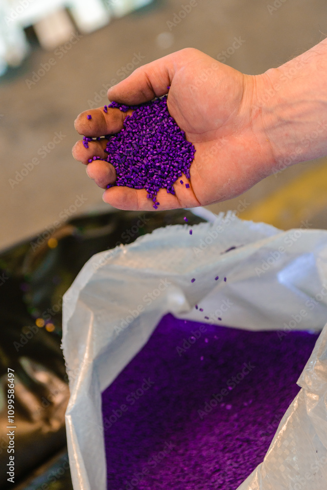Colorful polymer masterbatch granules poured by hand isolated on white ...