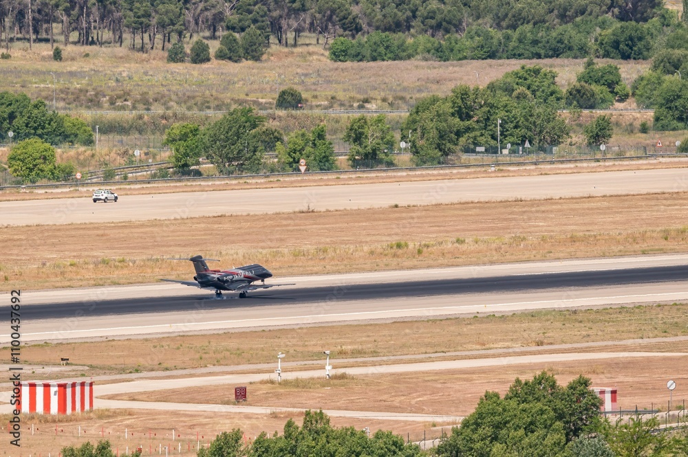 Madrid, Spain; 05-18-2024: Eye-catching gray and red private plane of ...