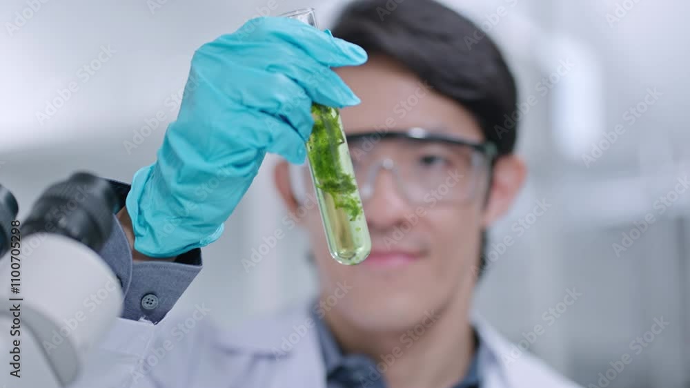 young male scientist using a microscope.people working at laboratory ...