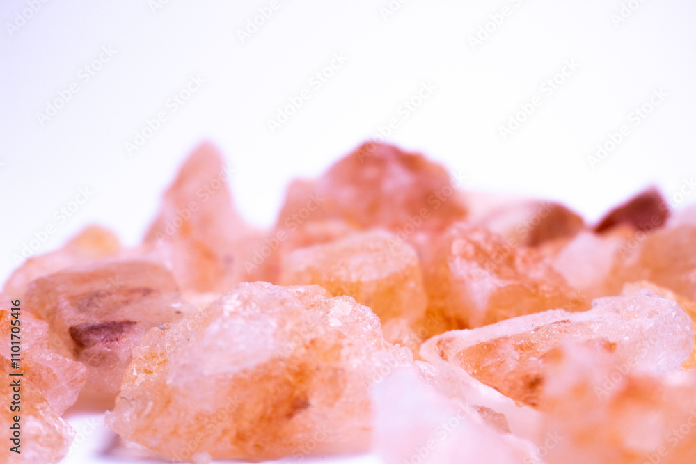 A pile of pink rocks on a white background. The rocks are of different ...