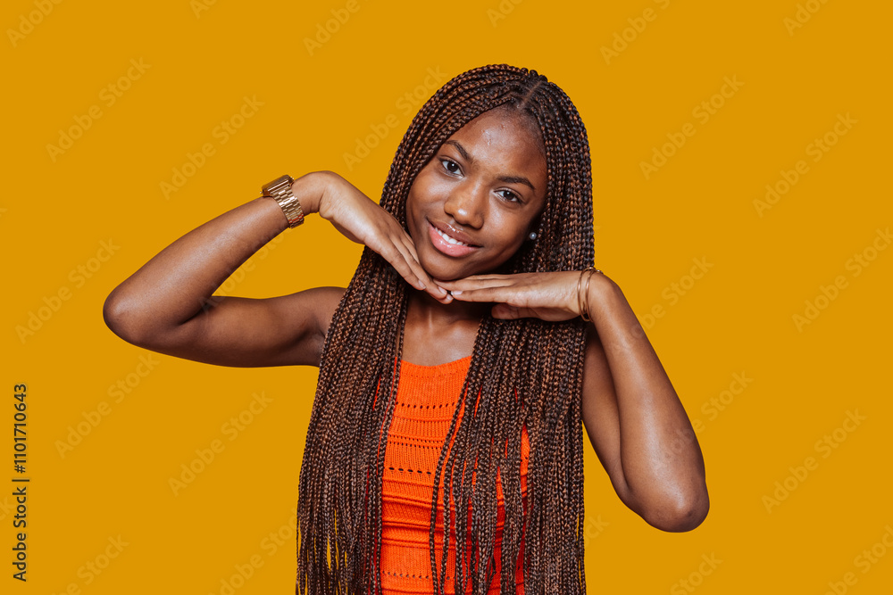 Smiling young black woman with long box braids framing her face with ...