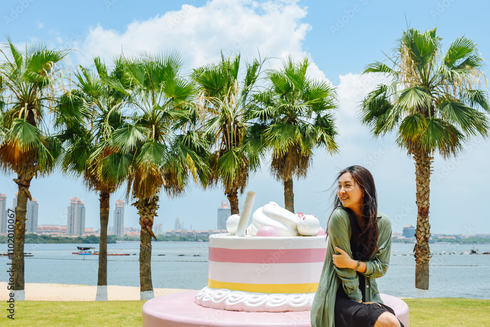 In early June, an Asian woman is enjoying herself on the beach at the ...