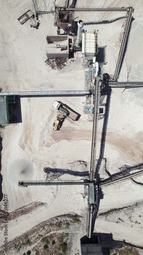 Front loader loading dumper truck with crushed stone. Stone crushing ...