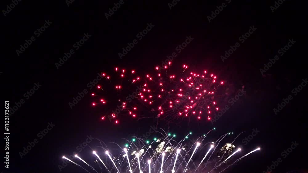 A fireworks display is lighting up the night sky with bursts of ...