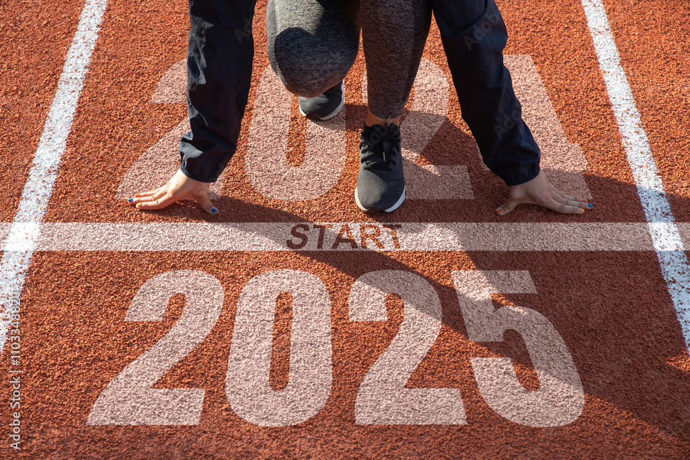 Starting to the new year 2025. woman preparing to start on an athletics ...