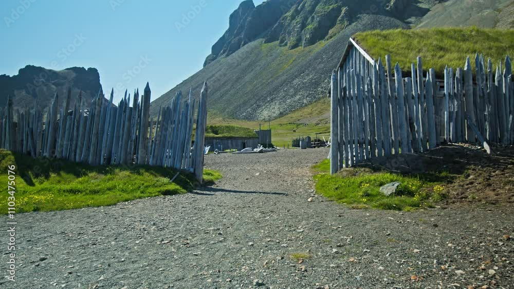 Viking village with wooden houses, grass roofs and a long ship Viking ...