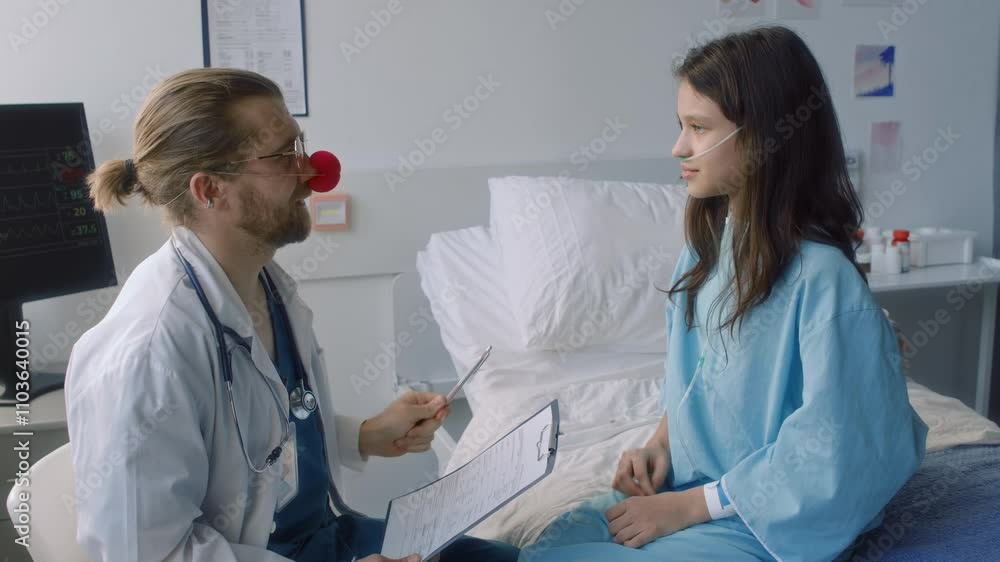 Side shot of cheerful male pediatric neurologist with red nose checking ...