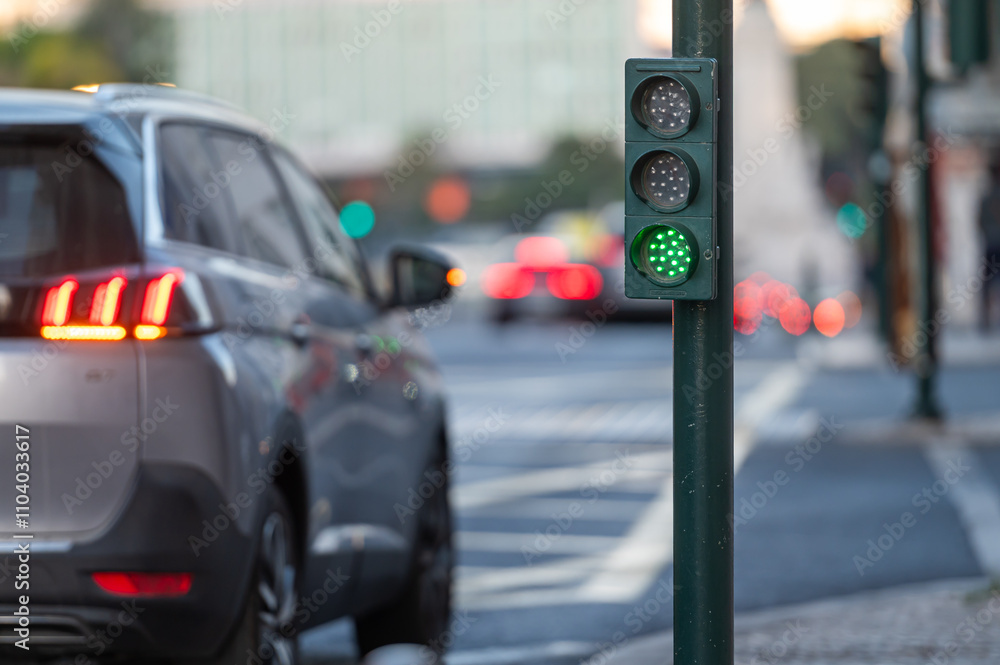 Poster Traffic light turns green as a car prepares to move forward in ...