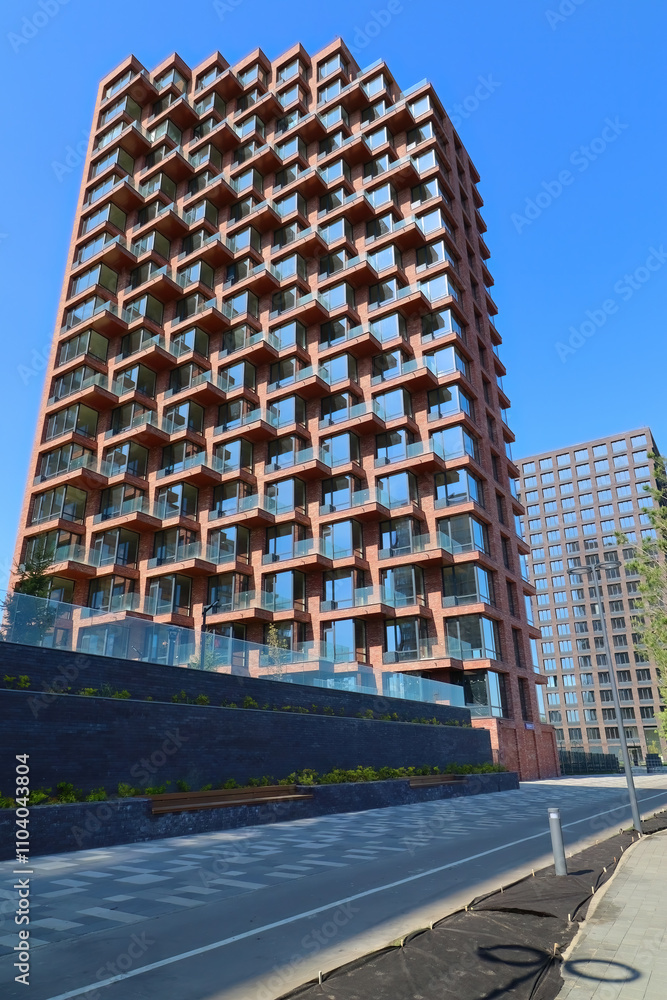 red brick building with many windows. building in city. building's ...