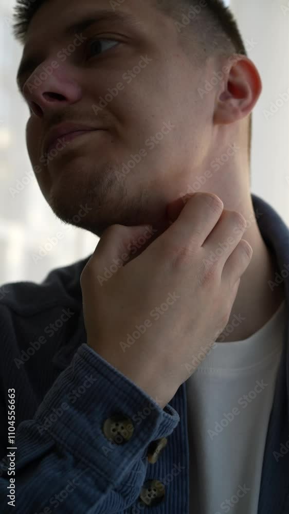 Itchy neck. A man scratches his neck with his hands. A bearded man ...