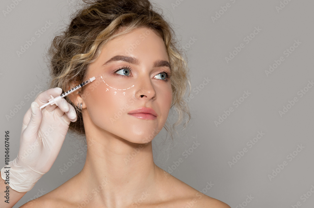 Beautician doctor making injection to young beautiful woman with drawn ...