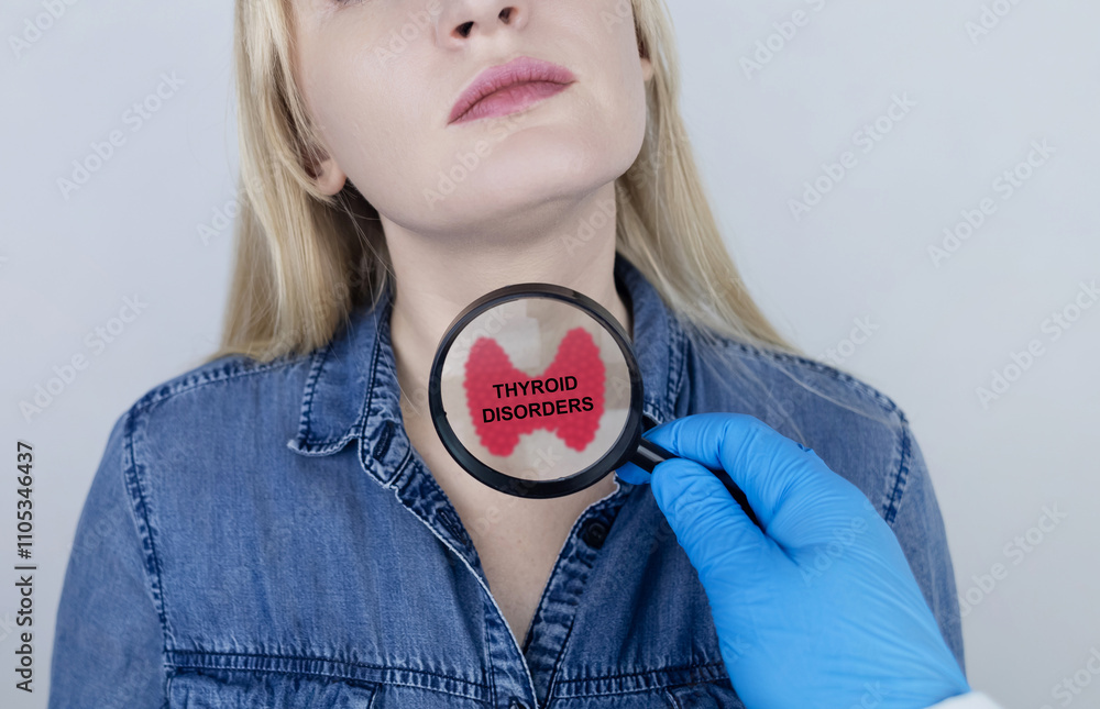 Thyroid disease. An endocrinologist examines a patient's thyroid gland ...