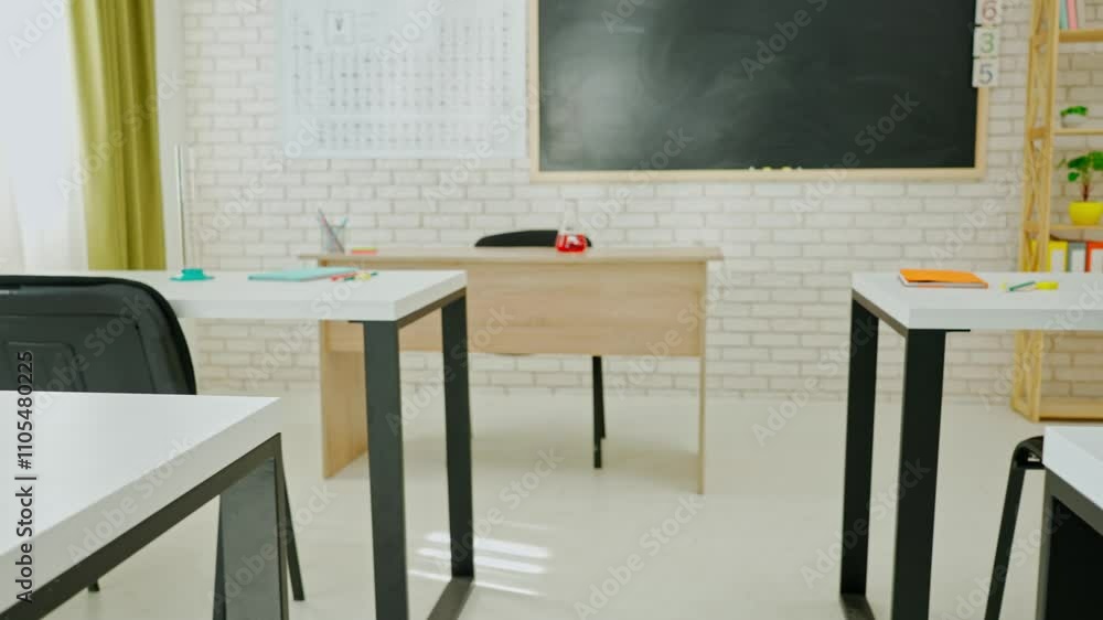 Empty school elementary classroom with desks, chairs and chalkboard ...