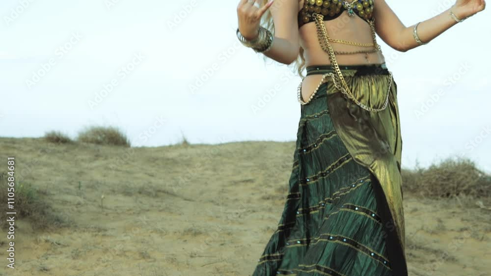 Professional belly dancer in stunning green and gold costume performs ...