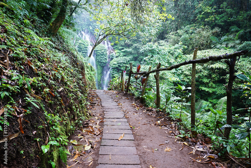 Foot path at Banyu Wana Amertha Waterfall with wooden fence. Natural ...