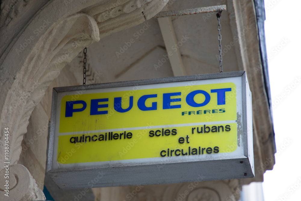 peugeot sign and vintage logo of cycles vintage store wall entrance of ...