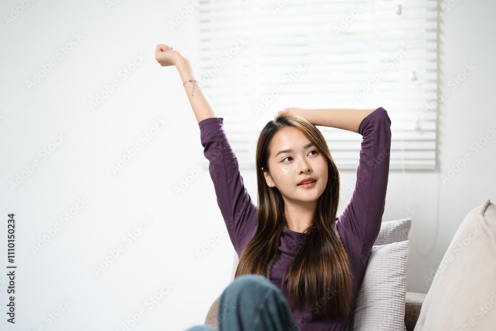 Lazy young lady sit in relaxed pose on big comfy sofa at living room ...