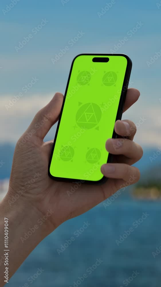GREEN SCREEN CHROMA KEY A hand holding a smartphone with a green screen ...