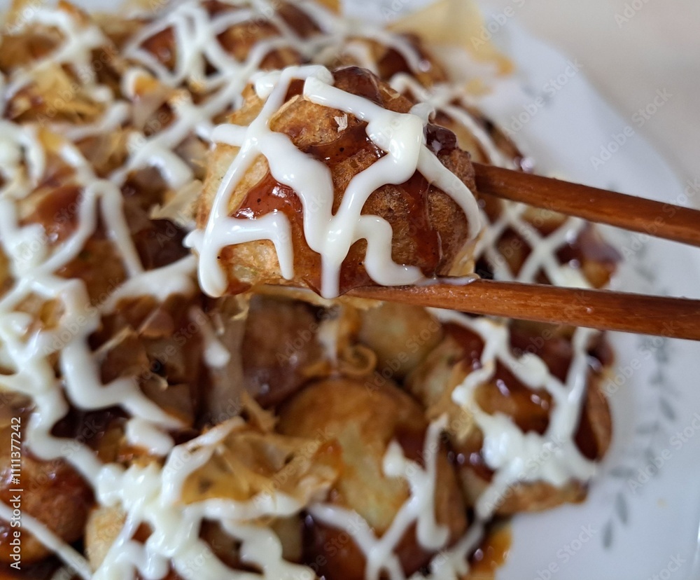 Takoyaki, a popular Japanese street food, are crispy round dough balls ...