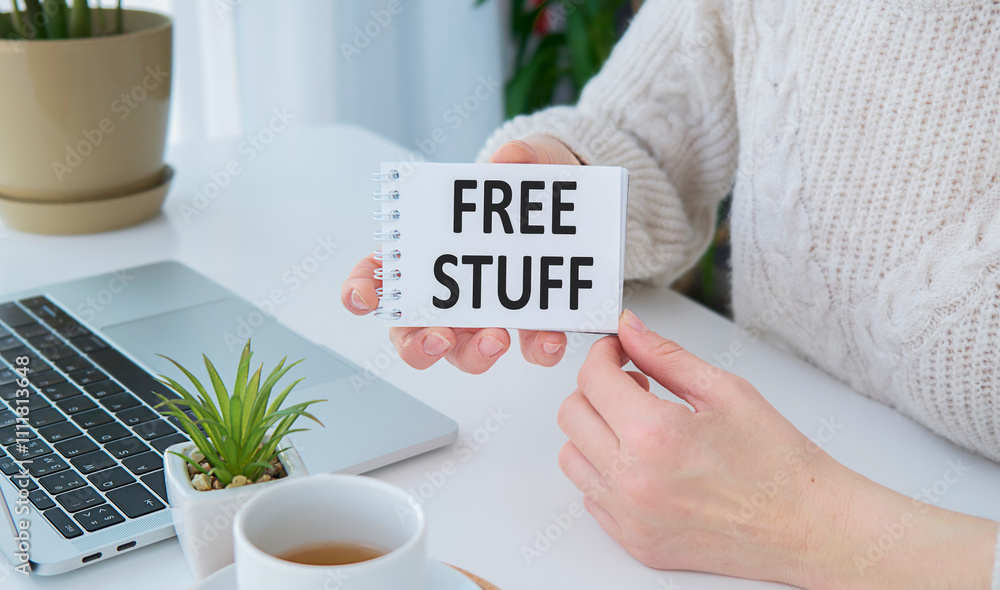 FREE STUFF text on notepad in business woman hand on office desk ...