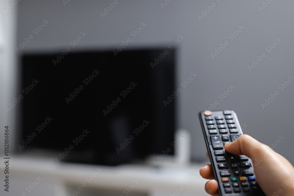 close up Television remote control in casual young female yellow shirt ...