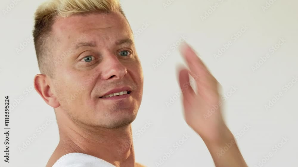 Facial freshness. Morning hygiene. Satisfied happy man with towel on ...