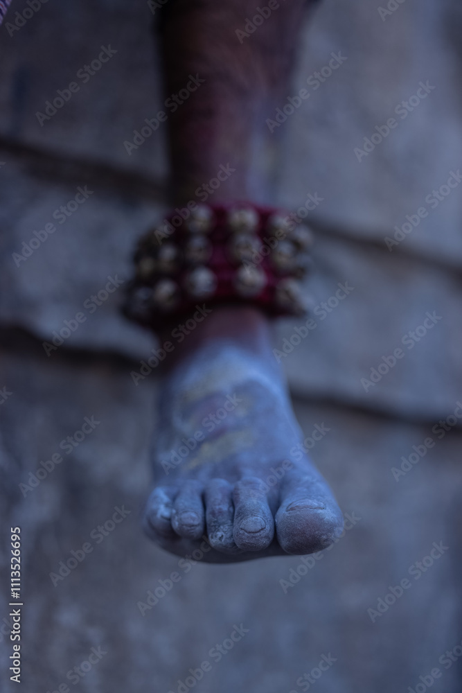 Shot of an human leg with ash painted on the leg during the masan holi ...