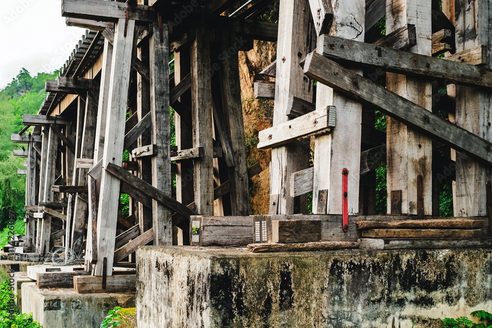 The ancient railway piers and large beams made of wood support an old ...